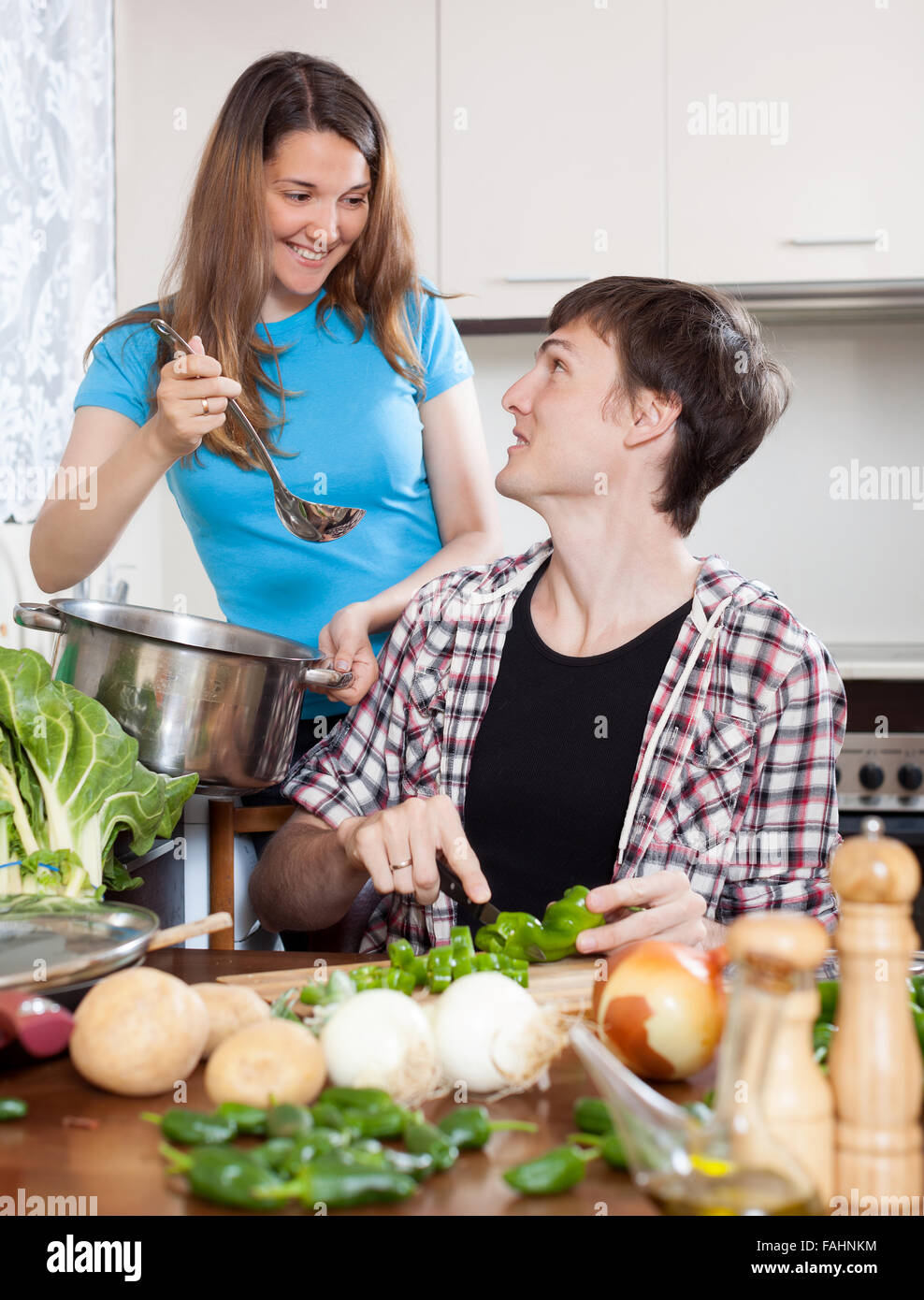 Happy family cooking in domestic kitchen Stock Photo - Alamy