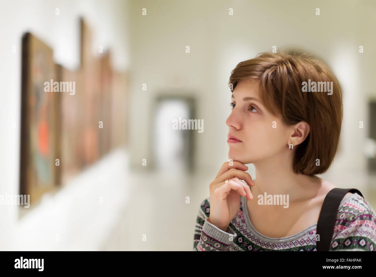 Girl looking pictures in gallery Stock Photo - Alamy