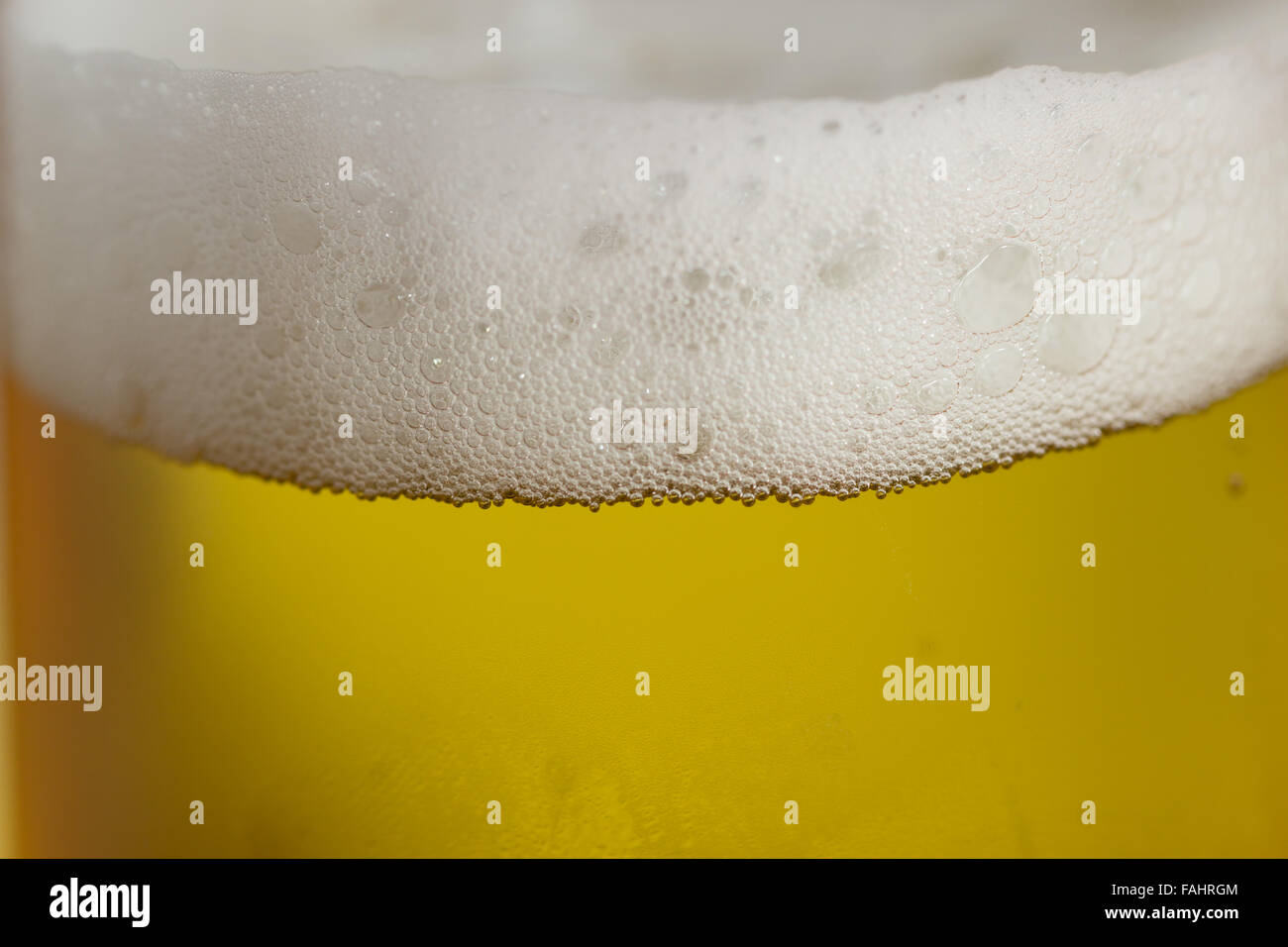 Surface of a glass of beer with foam and drops Stock Photo - Alamy