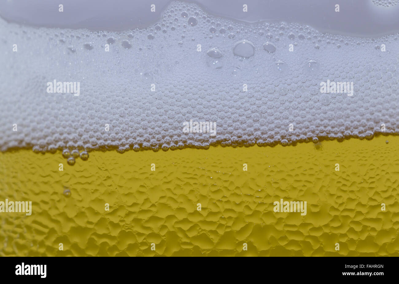 Surface of a glass of beer with foam and drops Stock Photo - Alamy