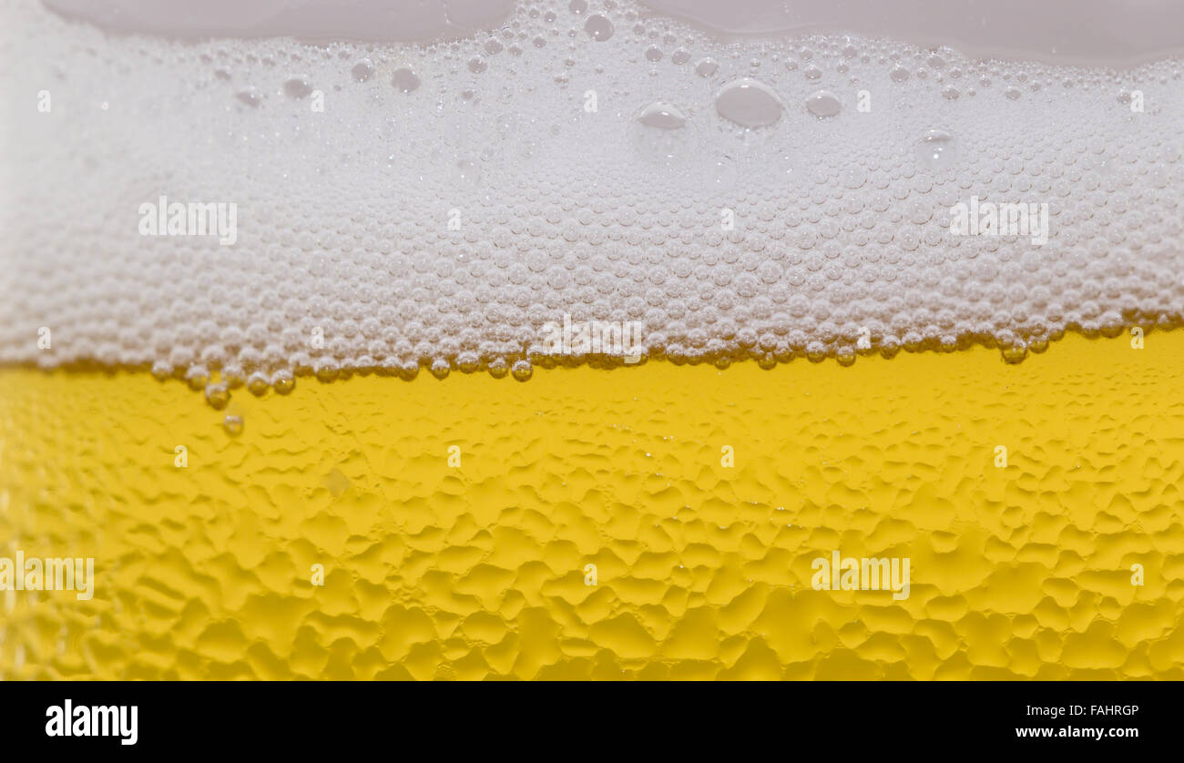 Surface of a glass of beer with foam and drops Stock Photo - Alamy