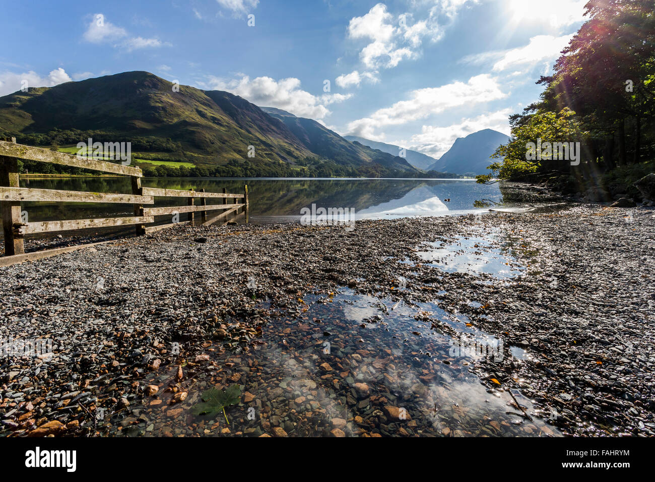 Lake Buttermere reflecting the surrounding hills on a bright sunny ...