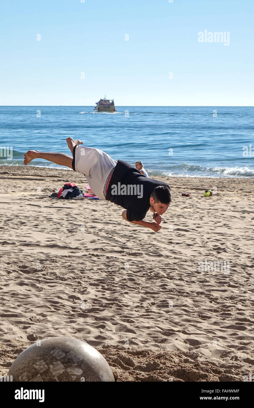 Young men practice tumbling, acrobatics, spinning and jumping on the ...
