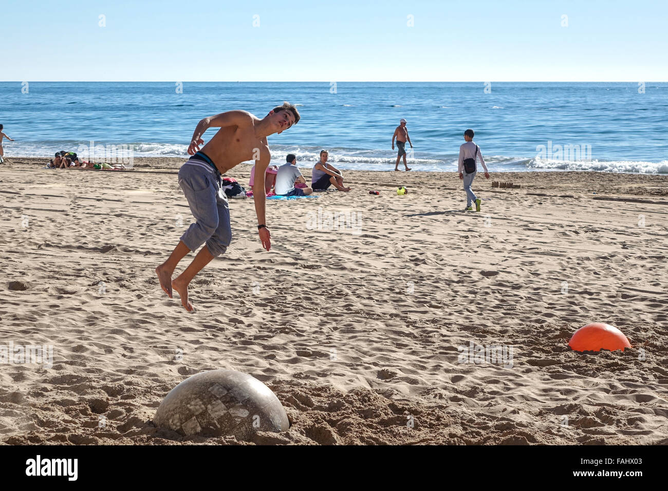 Young men practice tumbling, acrobatics, spinning and jumping on the ...
