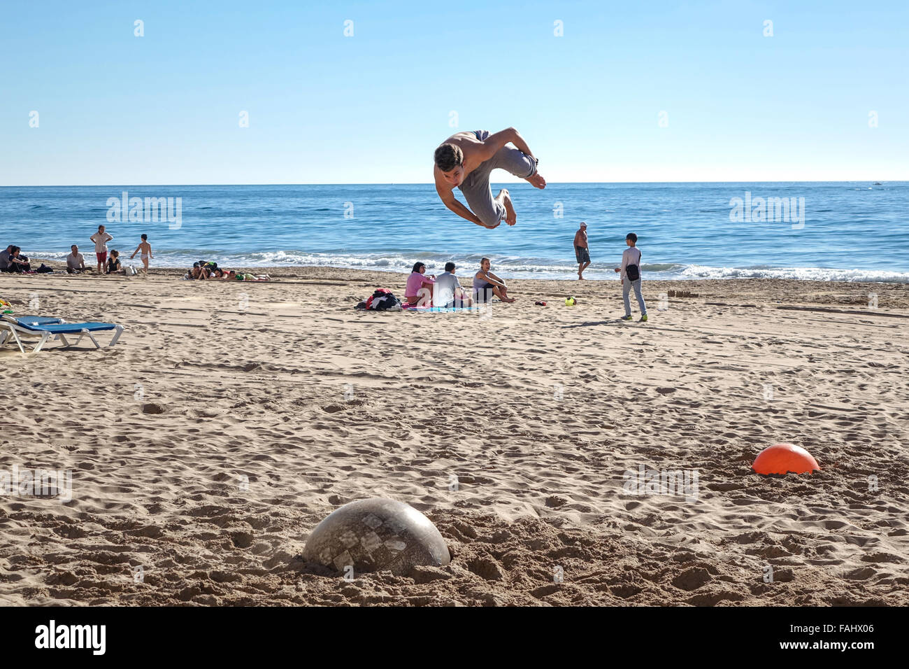 Young men practice tumbling, acrobatics, spinning and jumping on the ...