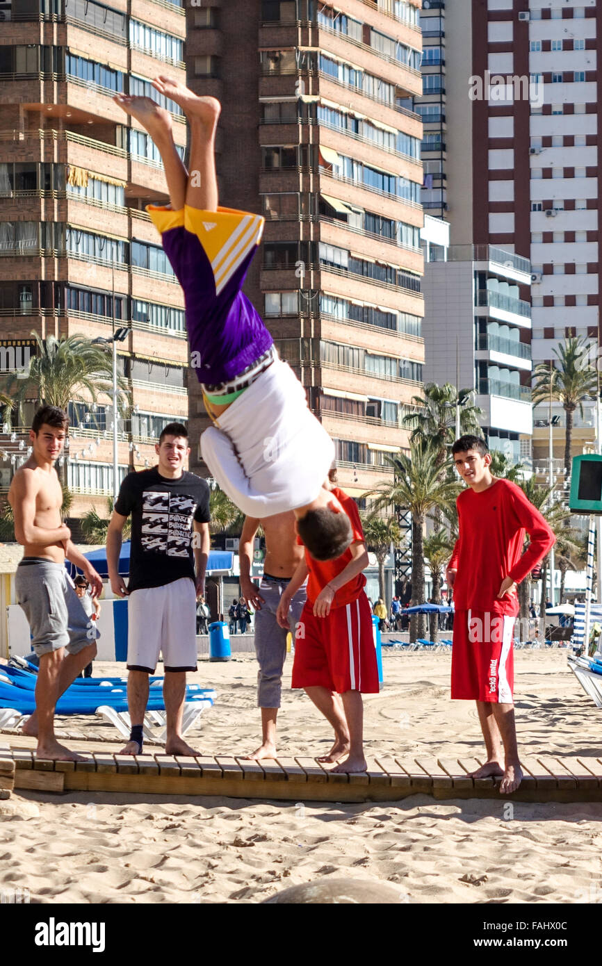Young men practice tumbling, acrobatics, spinning and jumping on the ...