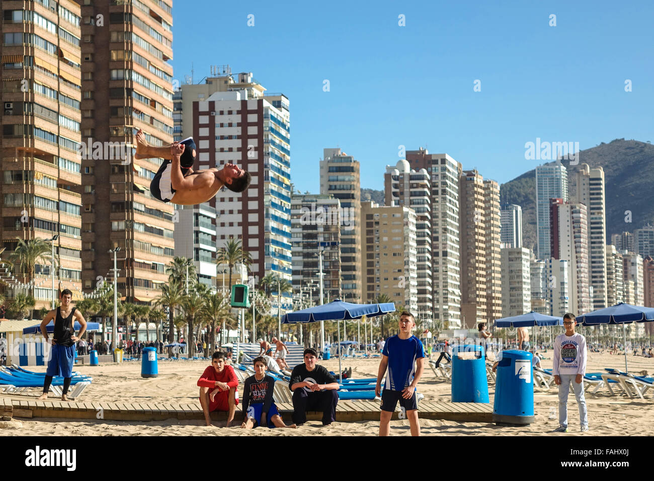 Young men practice tumbling, acrobatics, spinning and jumping on the ...