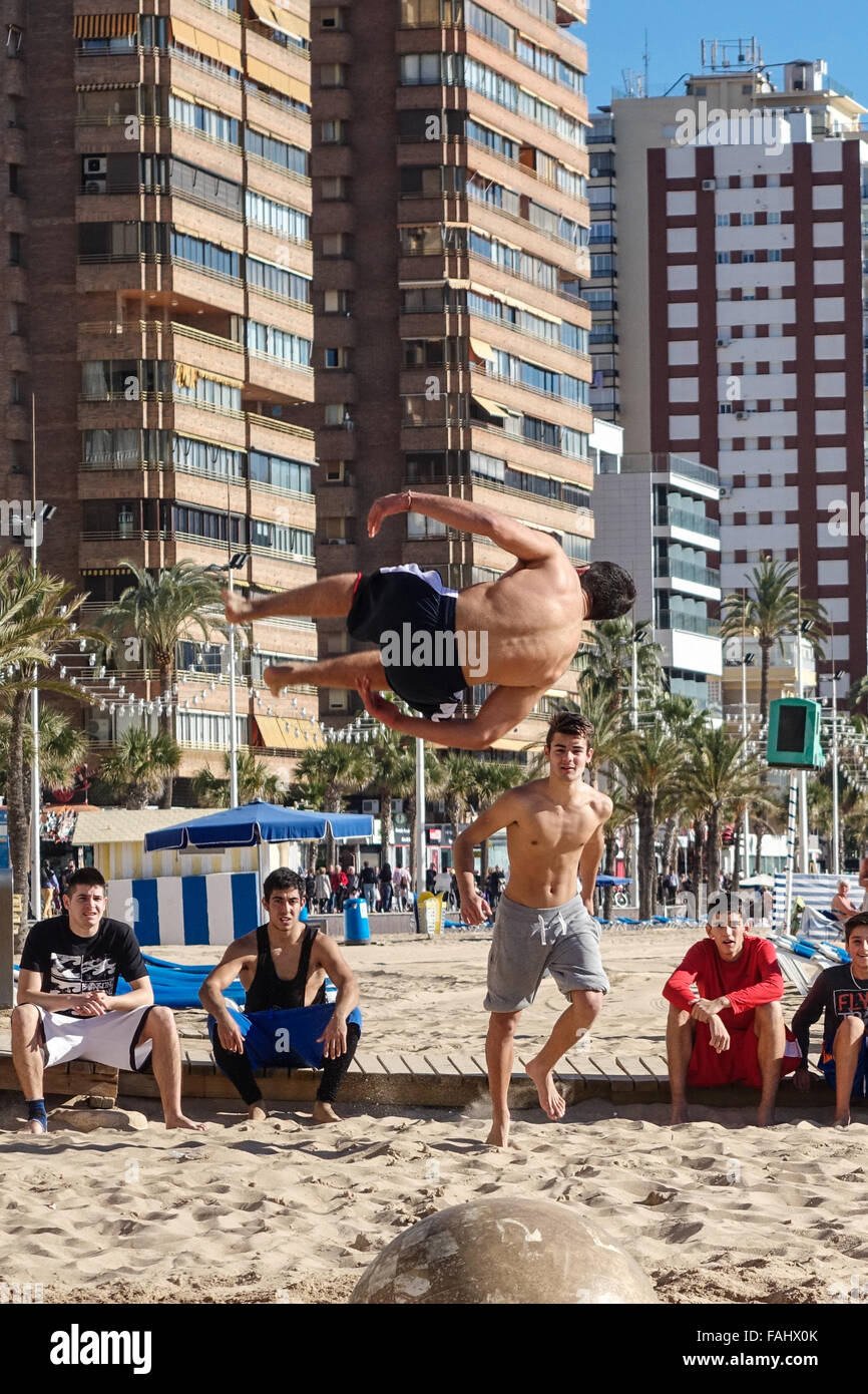 Young men practice tumbling, acrobatics, spinning and jumping on the ...