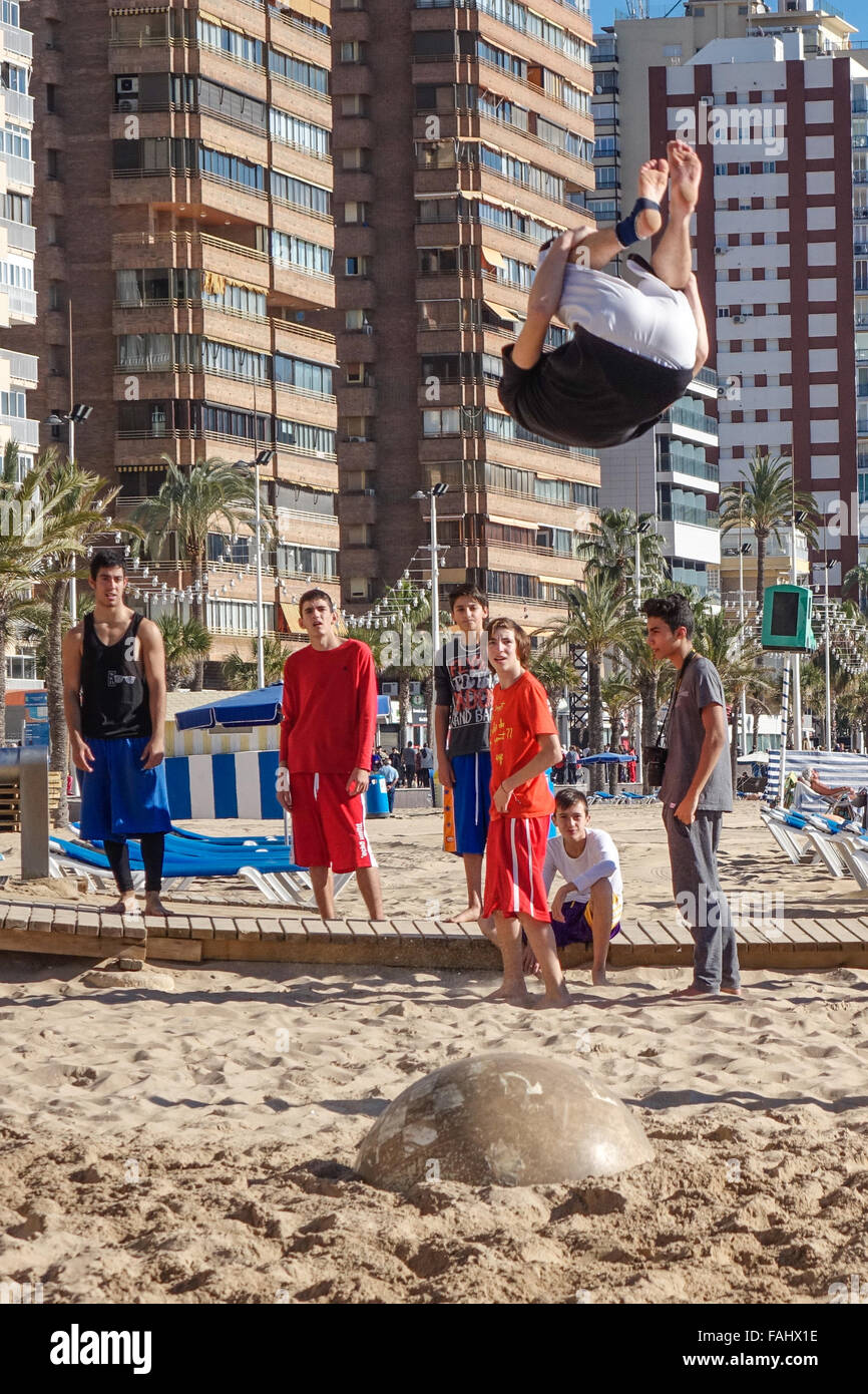 Young men practice tumbling, acrobatics, spinning and jumping on the ...