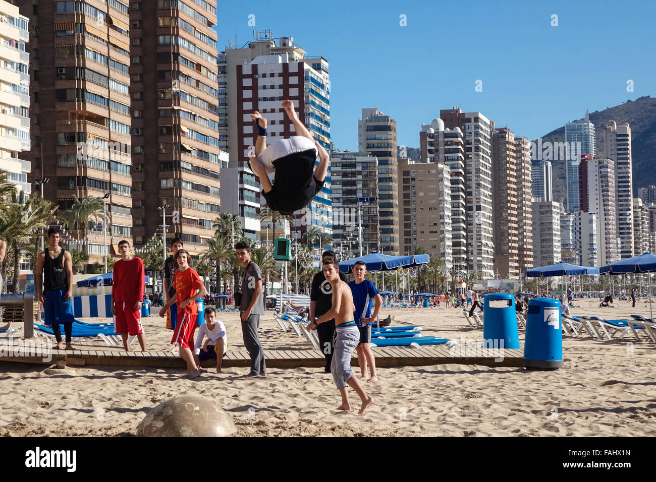 Young men practice tumbling, acrobatics, spinning and jumping on the ...
