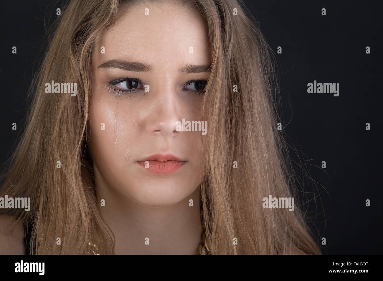 sad woman crying on black background Stock Photo - Alamy