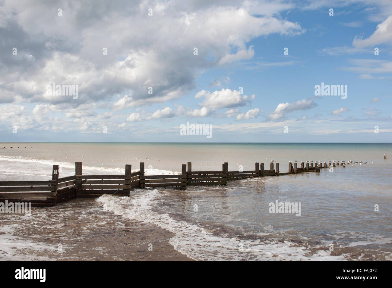 Breaking waves on a flat calm sea Stock Photo - Alamy