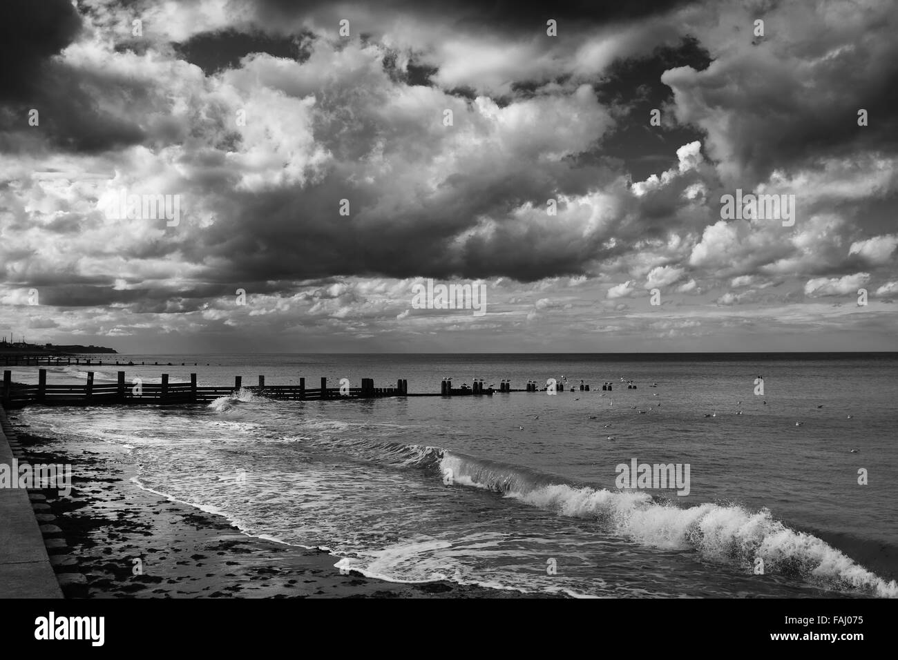 Breaking waves on a flat calm sea Stock Photo - Alamy