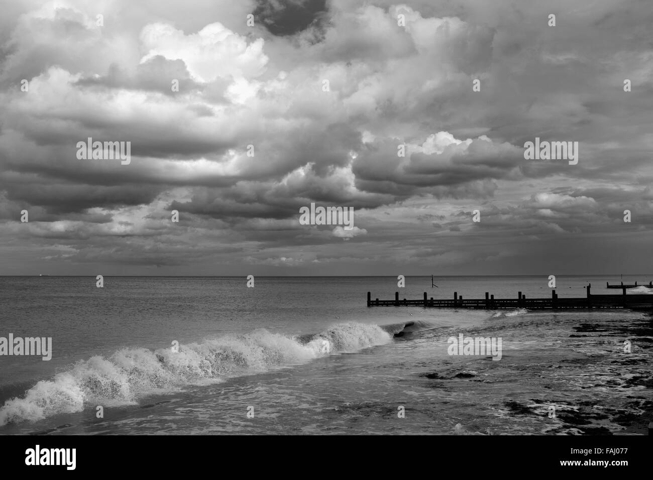 Breaking waves on a flat calm sea Stock Photo - Alamy