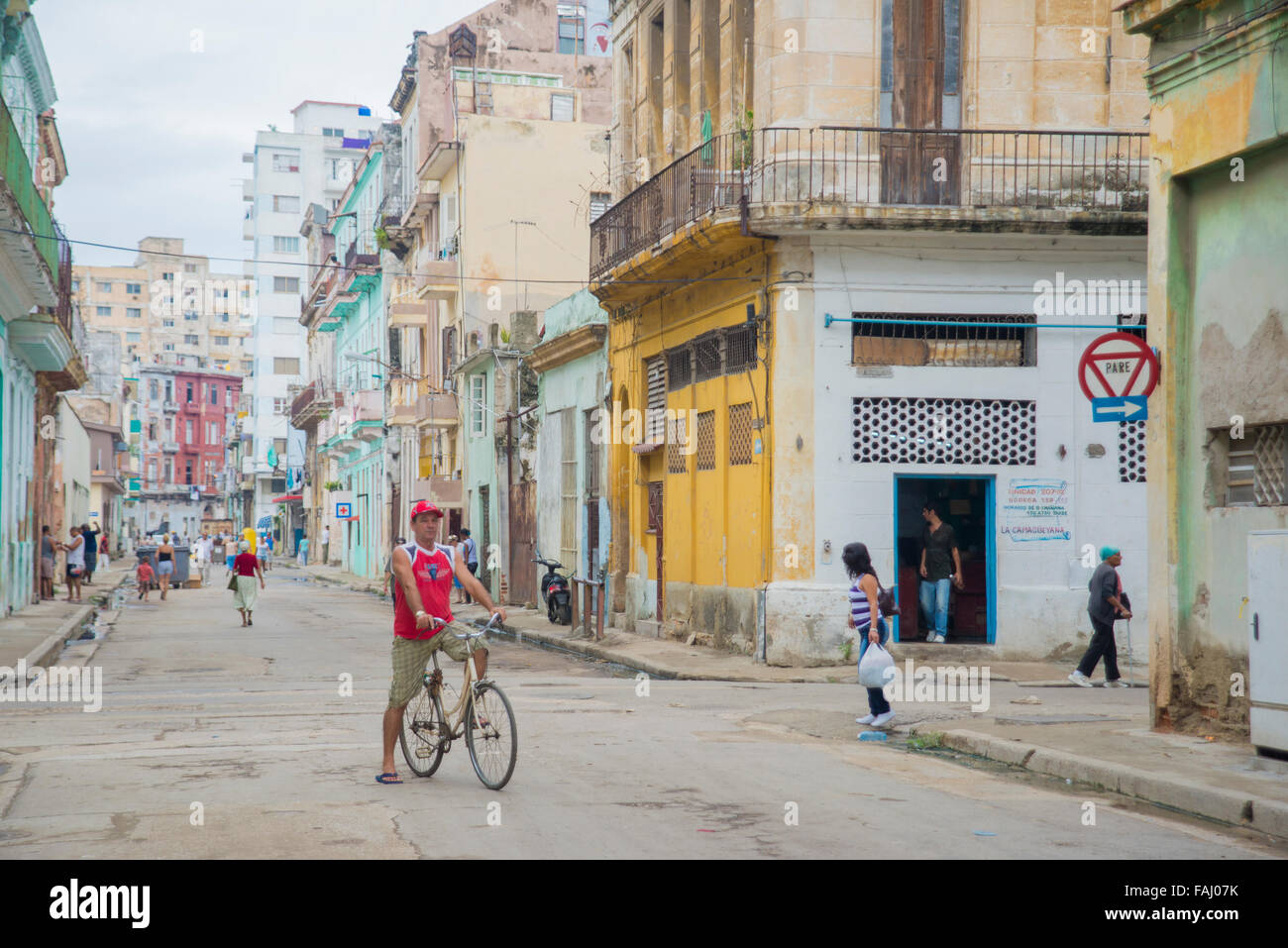 HAVANA, CUBA - DEC 4, 2015. People in an old decaying neighborhood in ...