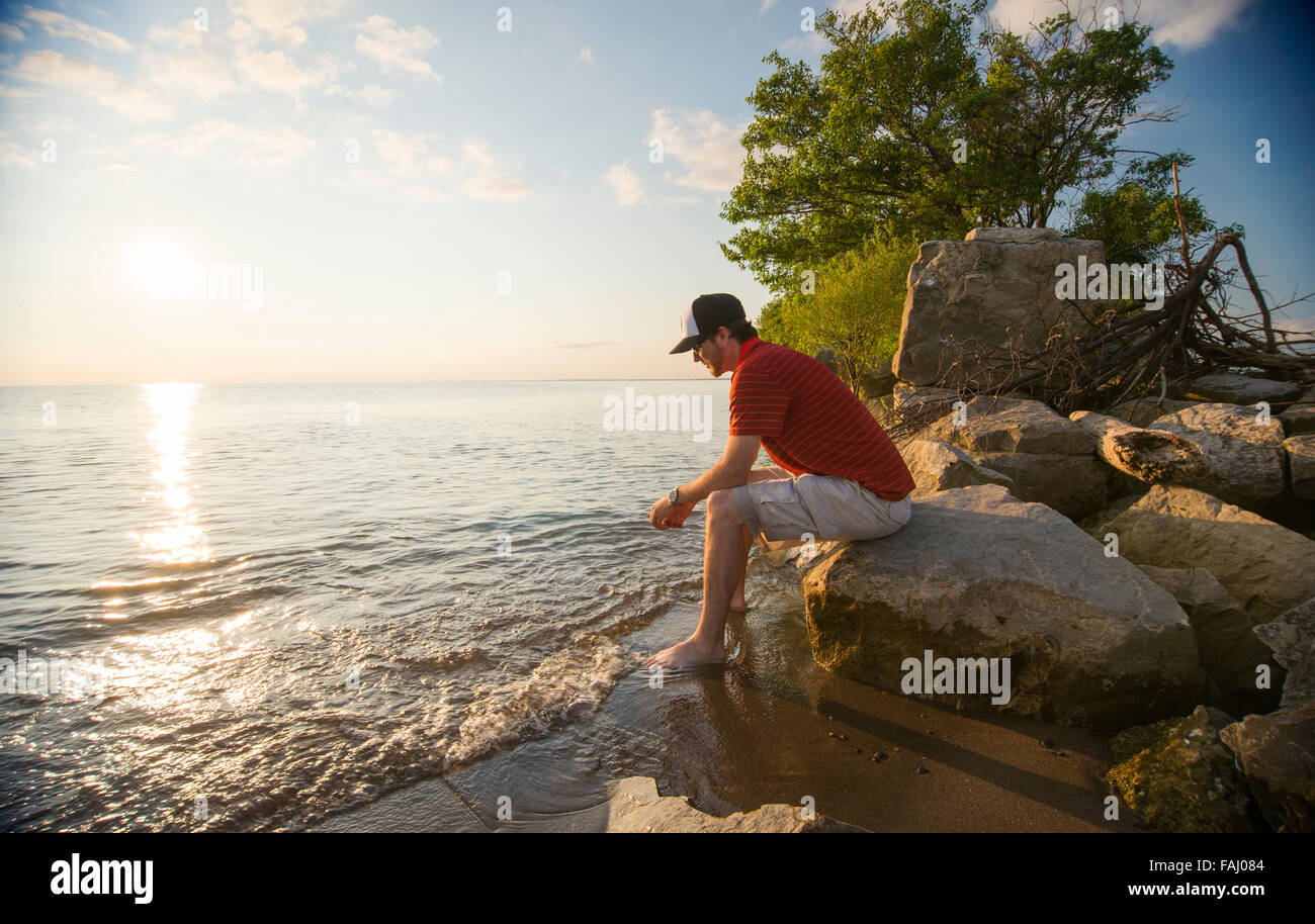 Man is sitting on a stone hi-res stock photography and images - Alamy