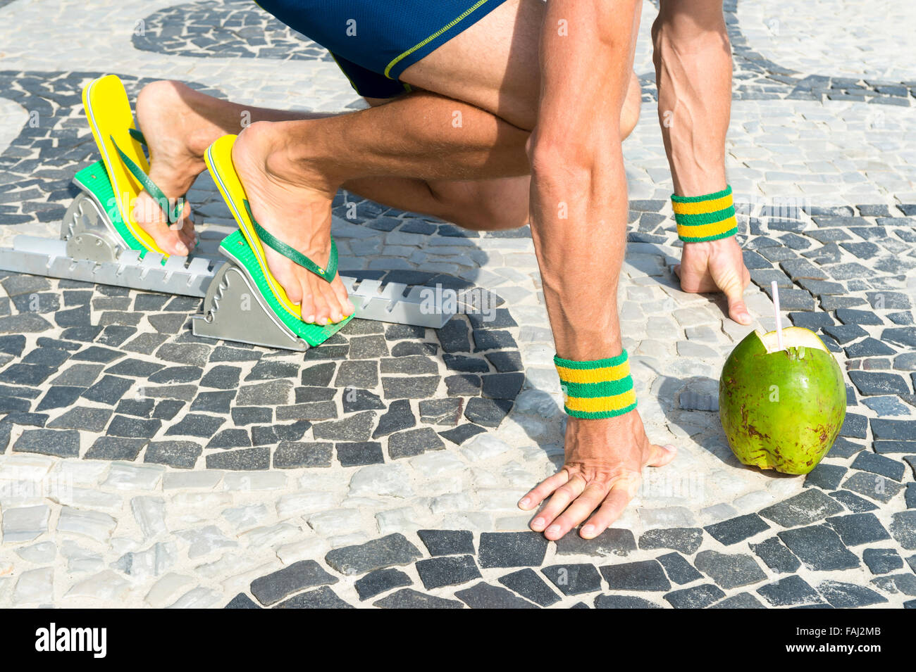 Brazilian athlete wearing flip flops crouching at the start position in ...
