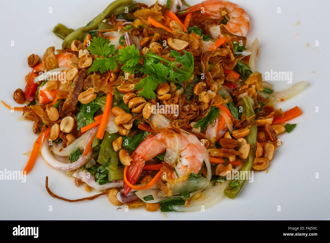 Traditional Asian seafood salad with nuts on wood background Stock ...