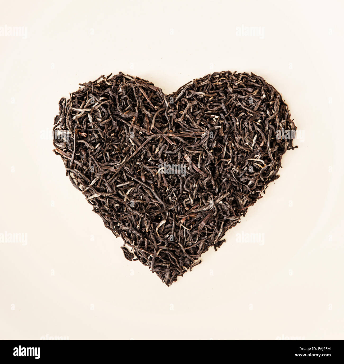 Heart of black loose tea from Ceylon. Valentine's day. Symbol of lovers ...