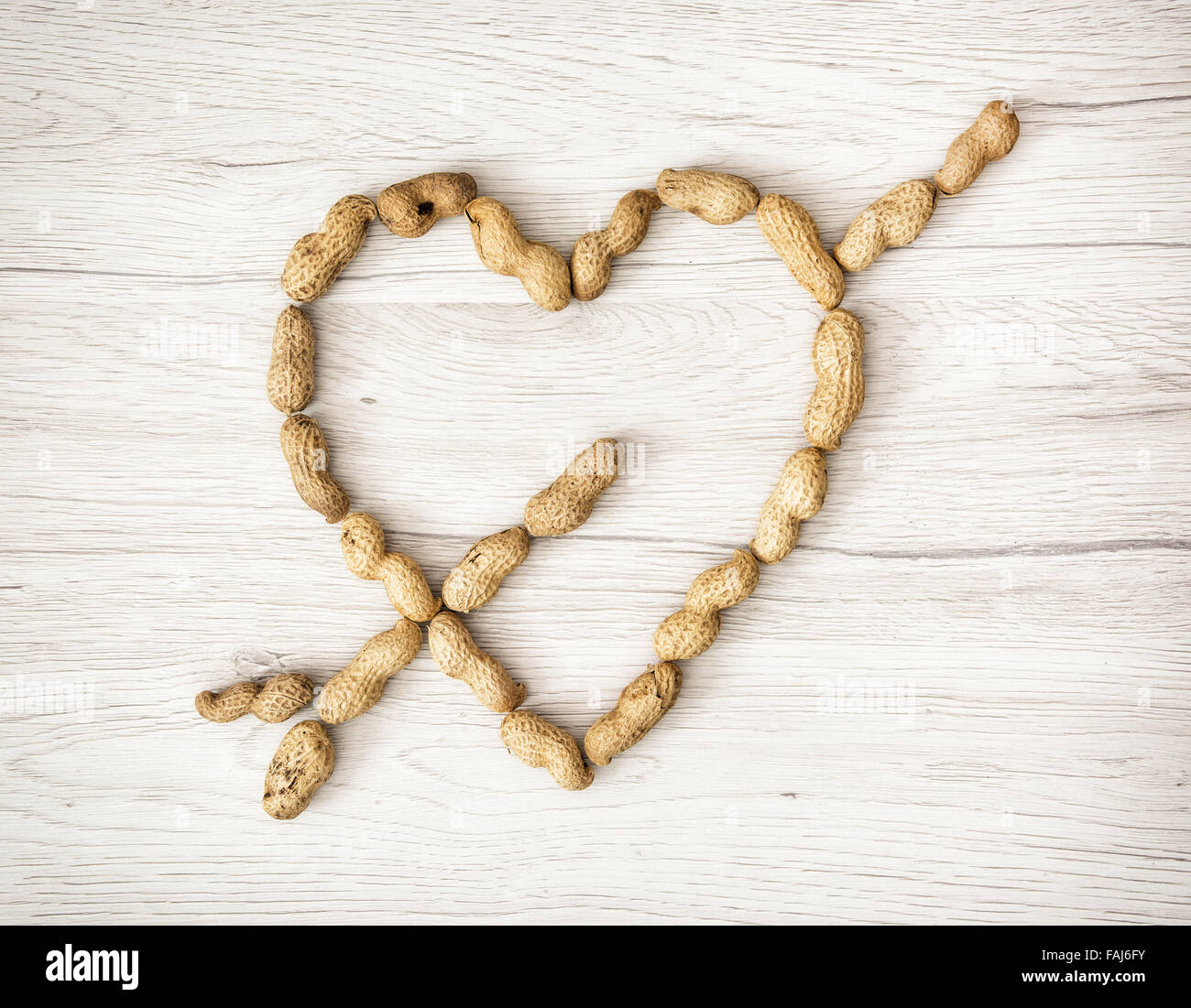 Heart of the peanuts on the wooden background. Valentine's day. Symbol ...