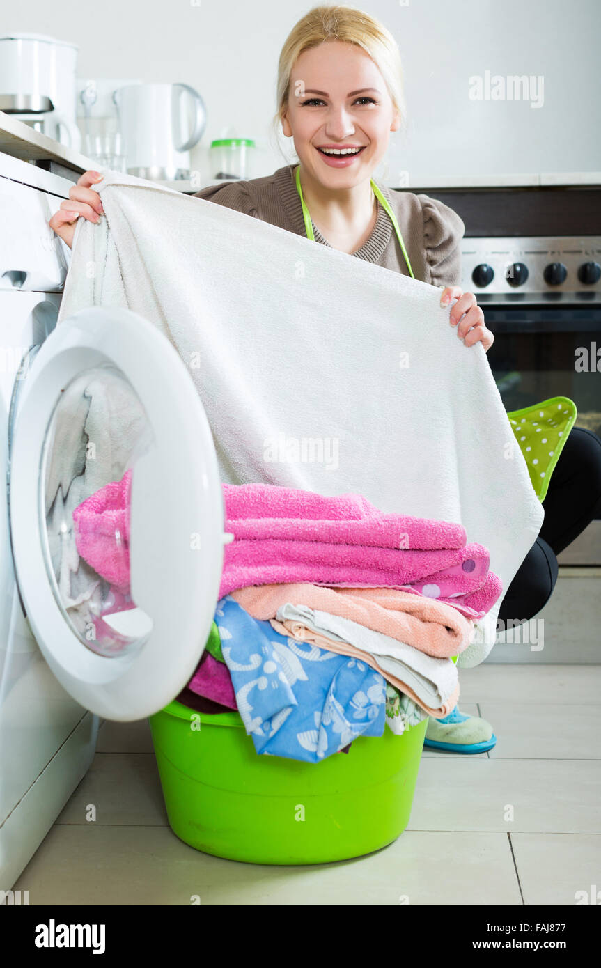 Happy american housewife using washing machine at home Stock Photo - Alamy