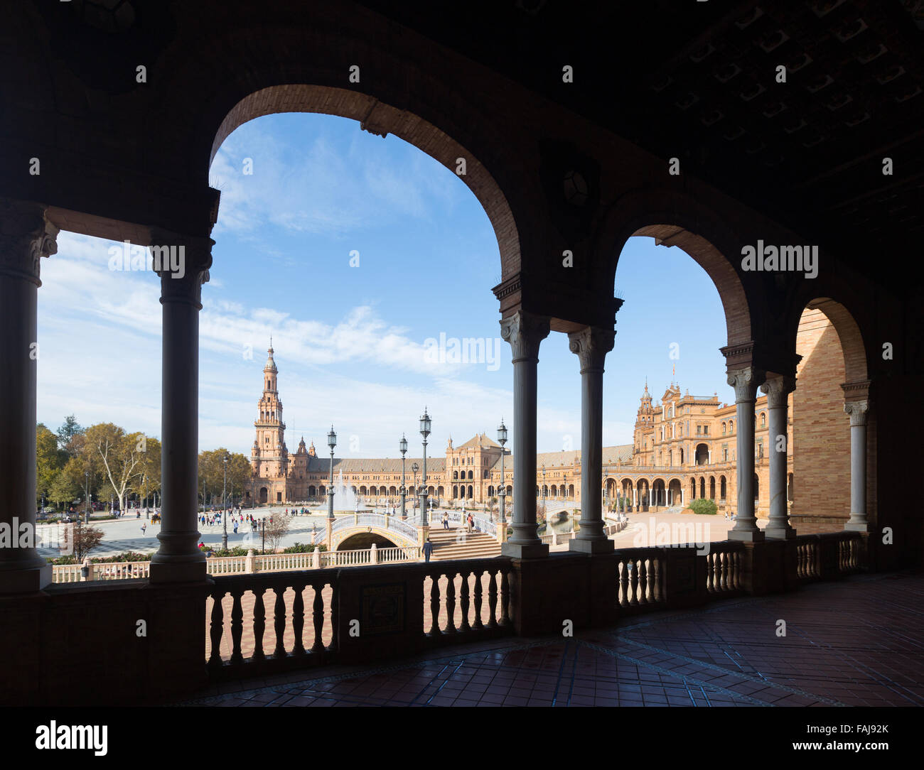 View through arches of gallery to Plaza de Espana. Seville Stock Photo ...