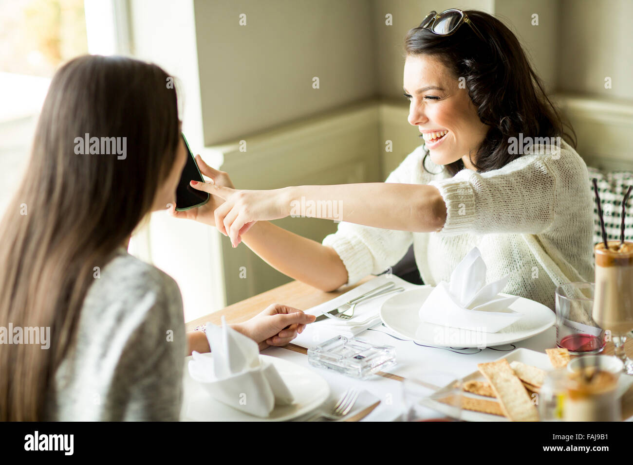 Young women in the restaurant Stock Photo - Alamy