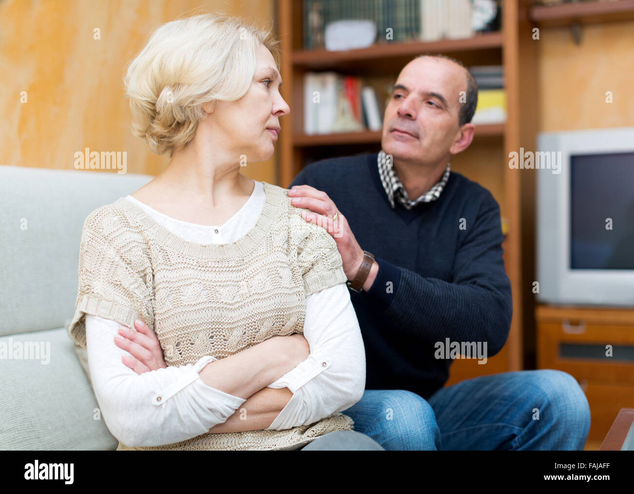 Elderly family couple being reconciled after argue at house. Focus on ...