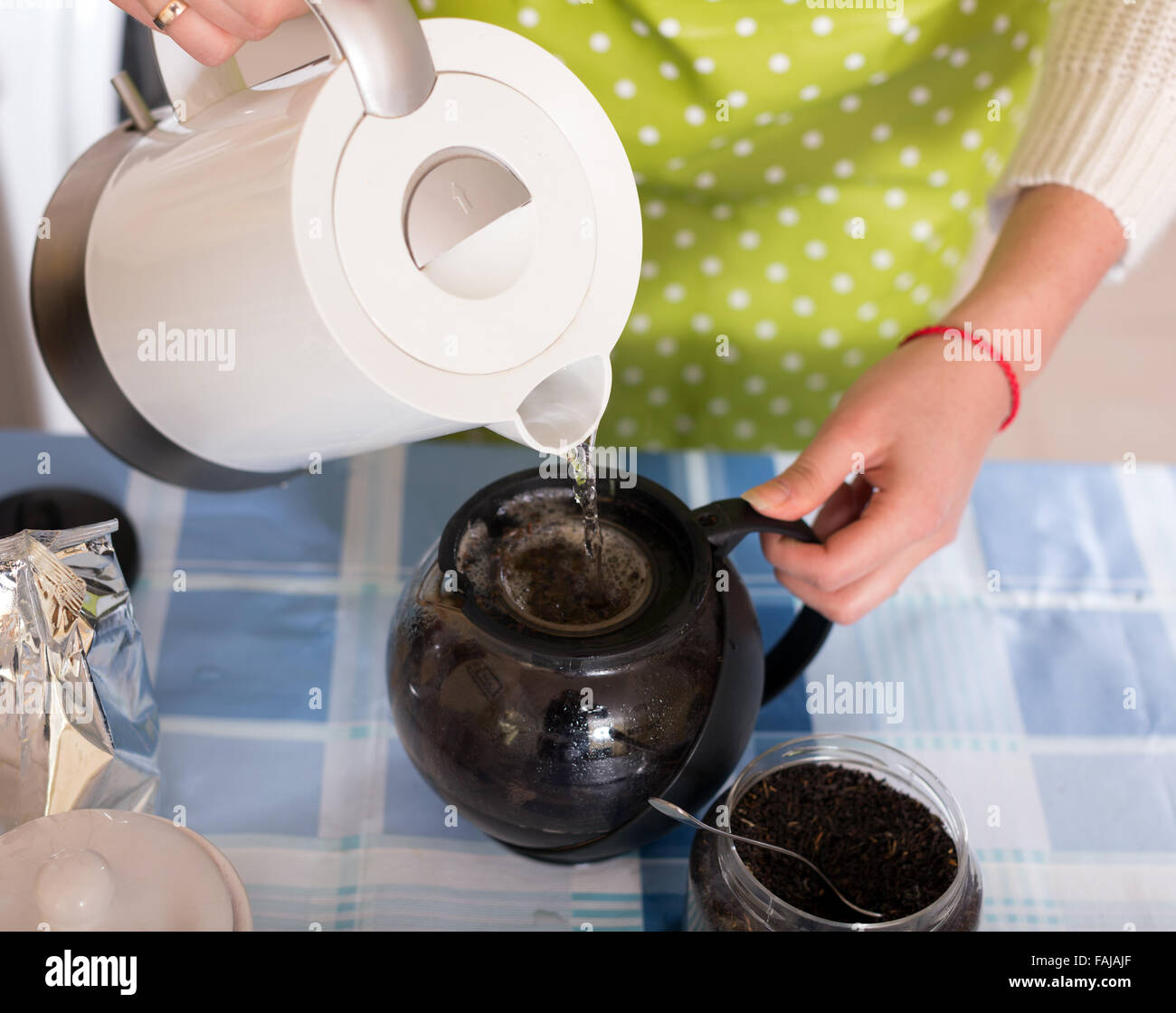 Closeup of housewife making tea in domestic kitchen Stock Photo - Alamy