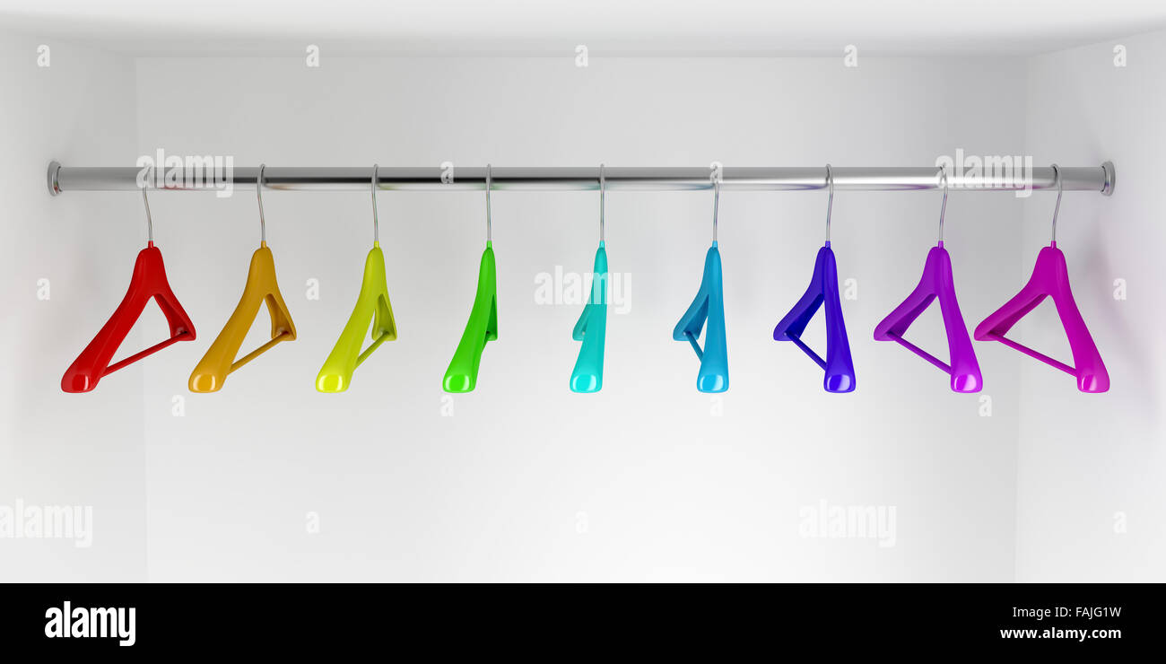 Rainbow colored hangers in the closet Stock Photo - Alamy