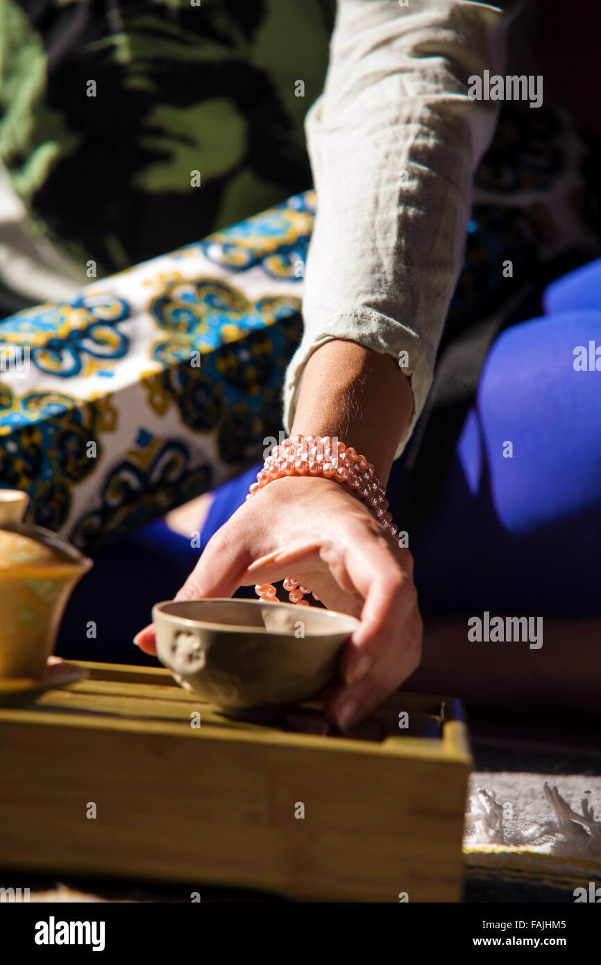 Female hand taking a cup with a tea Stock Photo - Alamy