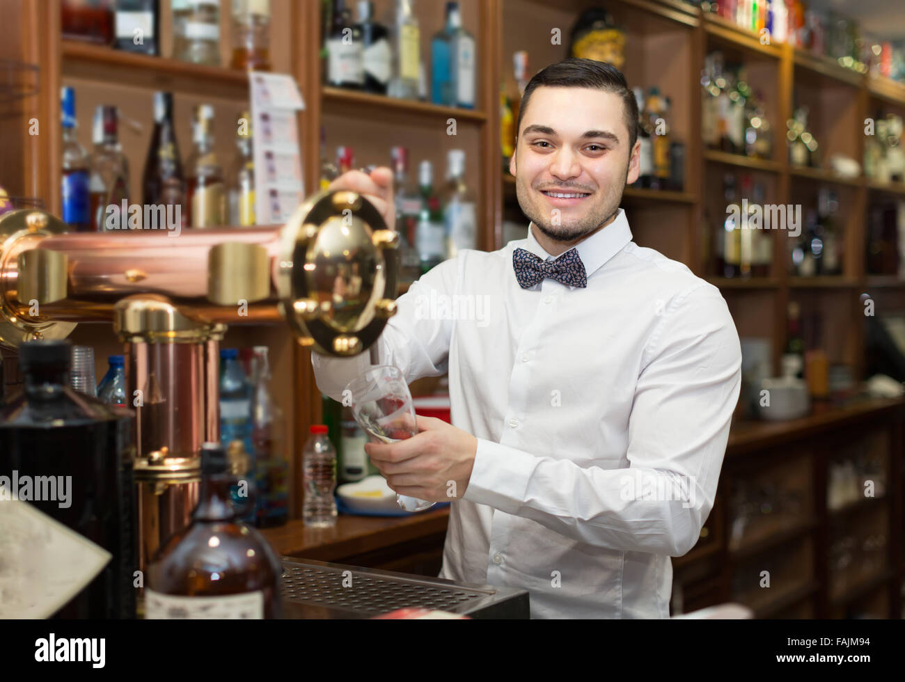 Modern bar with bottles at background and happy male bartender Stock ...