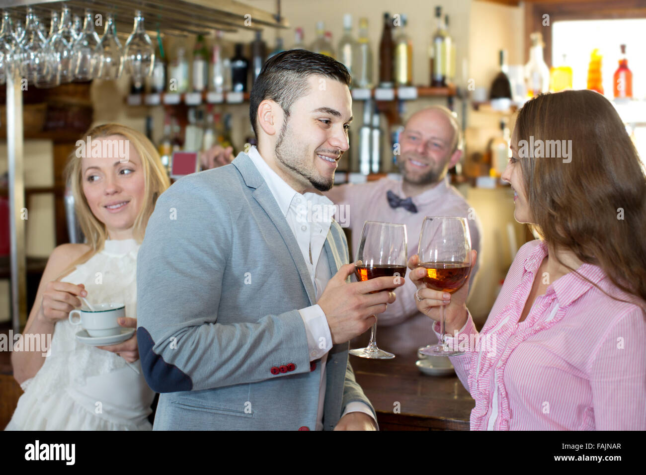 Restaurant happy visitors waiting for table and drinking wine at tavern ...