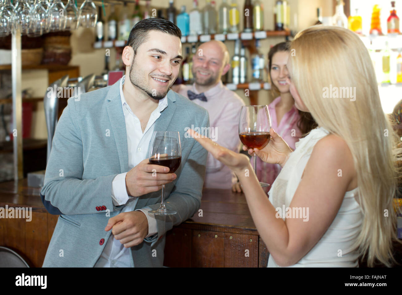 Portrait bar visitors waiting for table and drinking wine at tavern ...