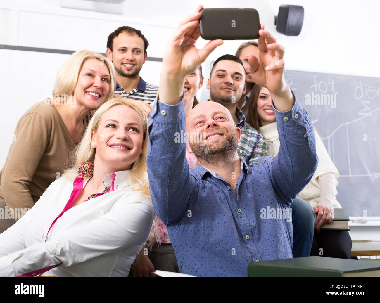 Professor creating a selfie with his students in a classroom Stock ...