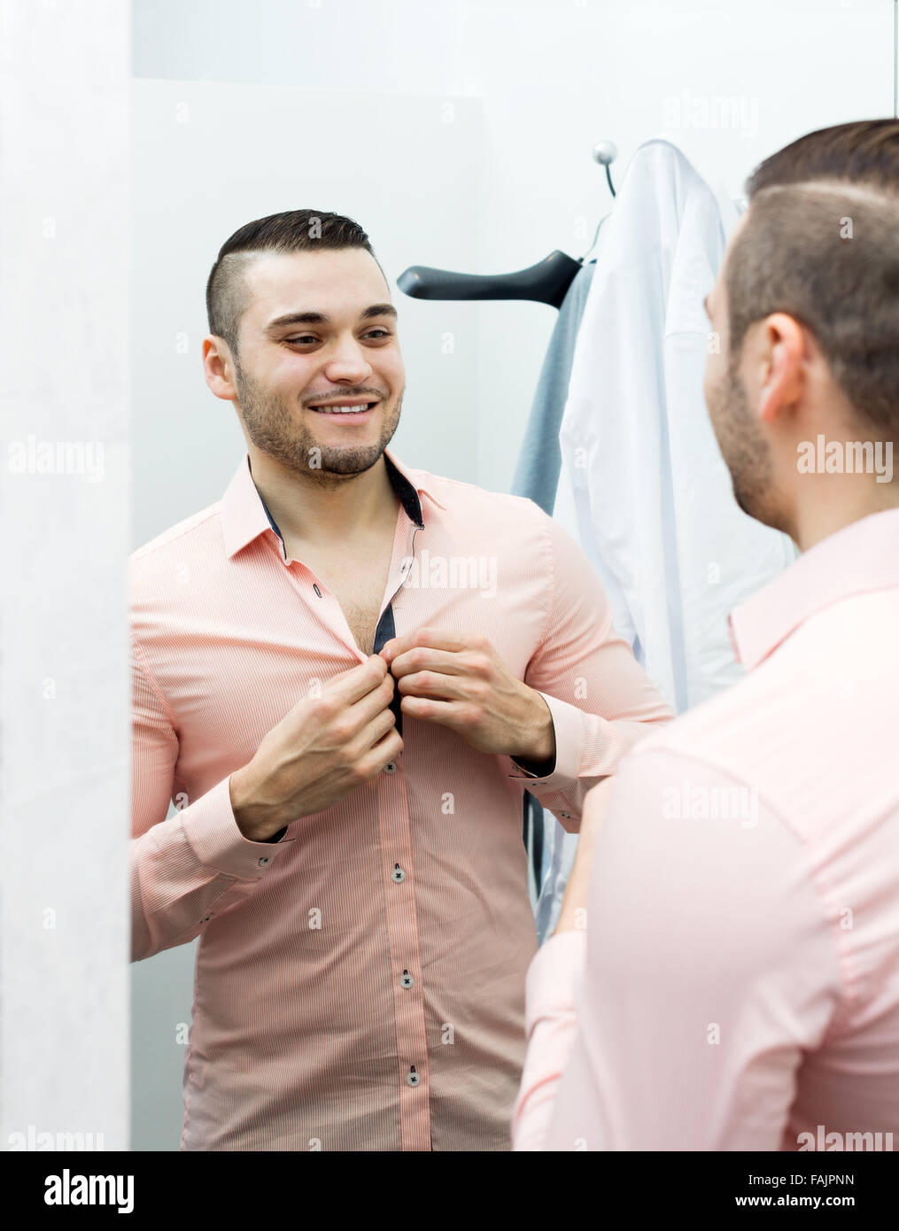 Portrait of happy male with new clothes at fitting-room Stock Photo - Alamy