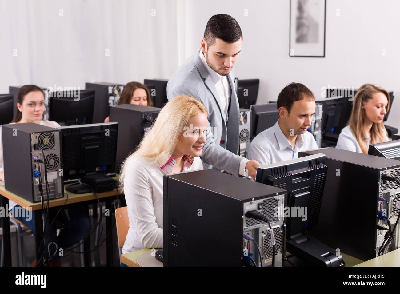 Sales department manager and employees working with computers at office ...