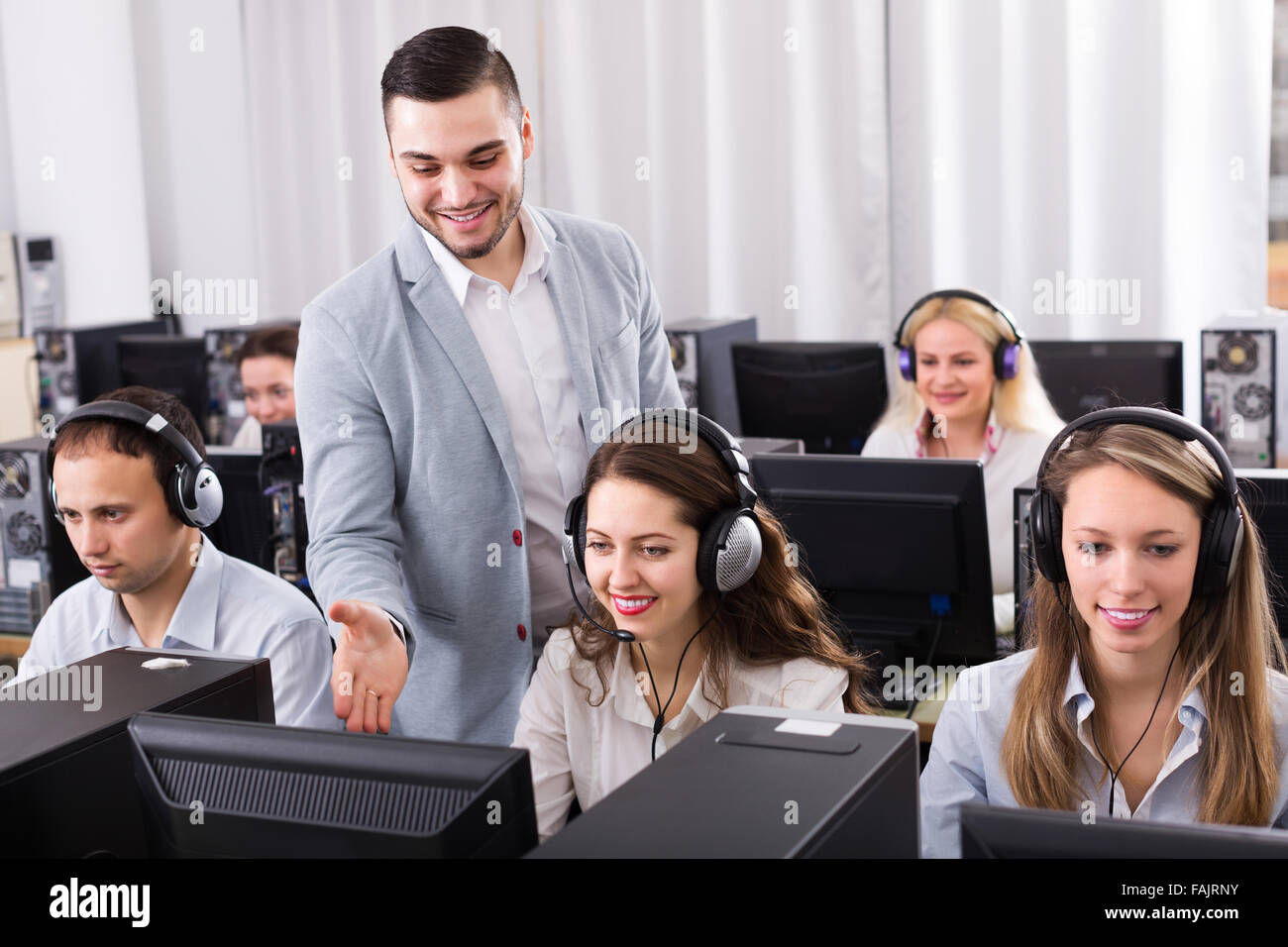 Friendly manager watching his business team working process Stock Photo ...