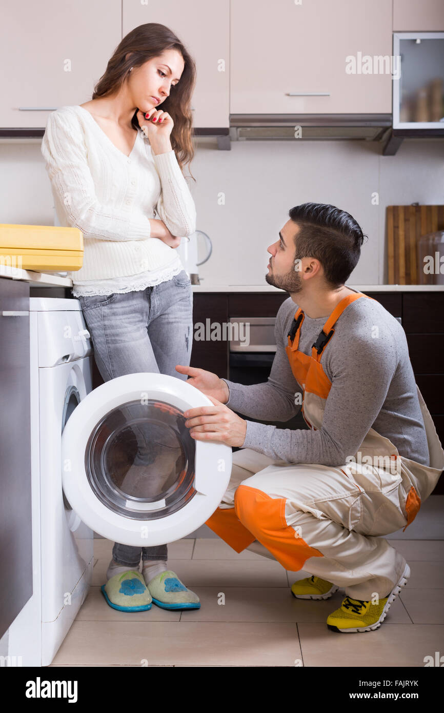 Professional workman visiting customer for after-sales service at home ...