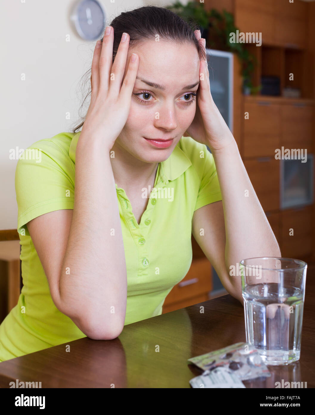 Depressed female sitting in silence and thinking about her problems ...