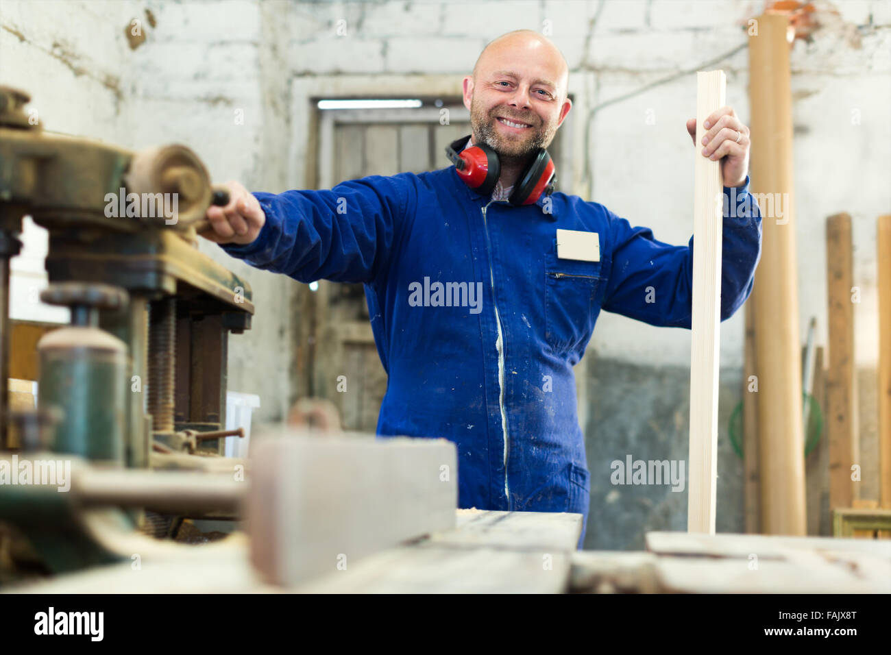 Male worker on lathe at wood workroom Stock Photo - Alamy