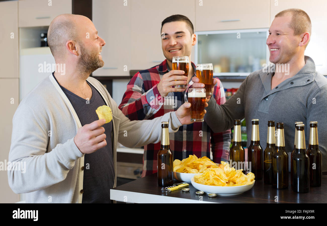 Three american men drinking beer and laughing at house party Stock ...