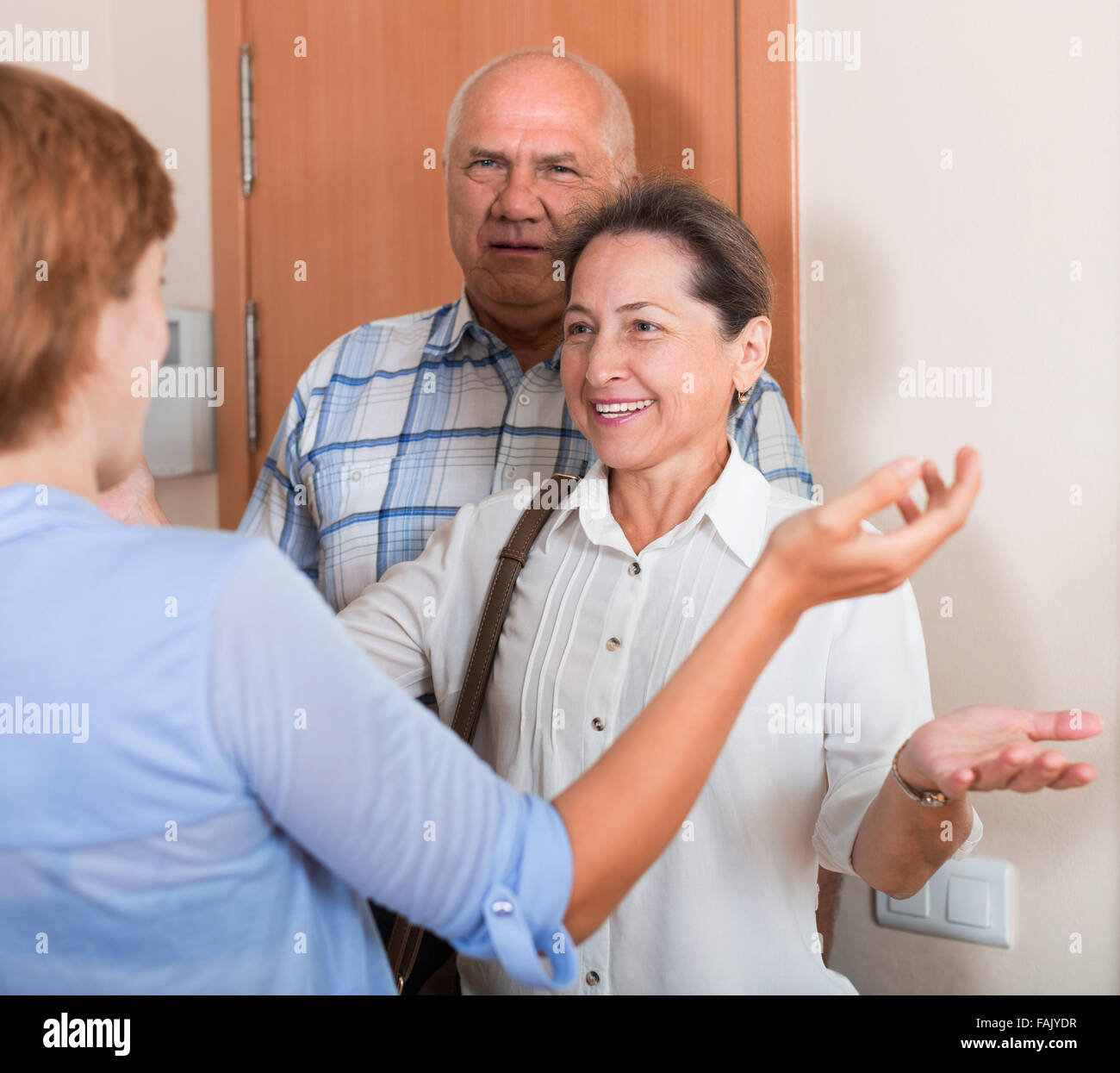 Daughter greeting elderly parents at threshold Stock Photo - Alamy