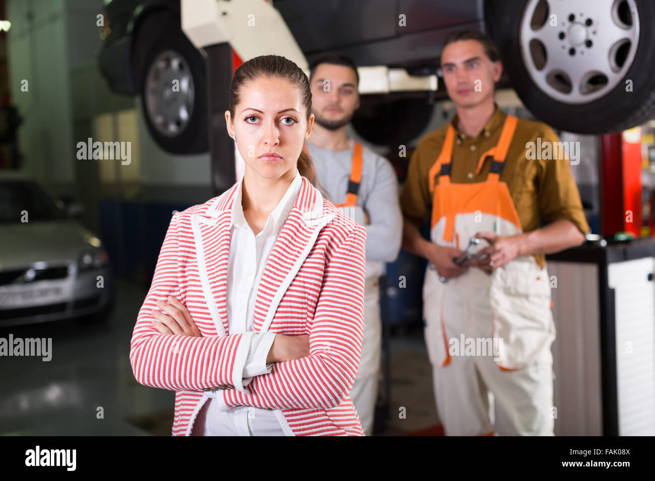 Tired unhappy female client duping by troubleshooters at auto service ...