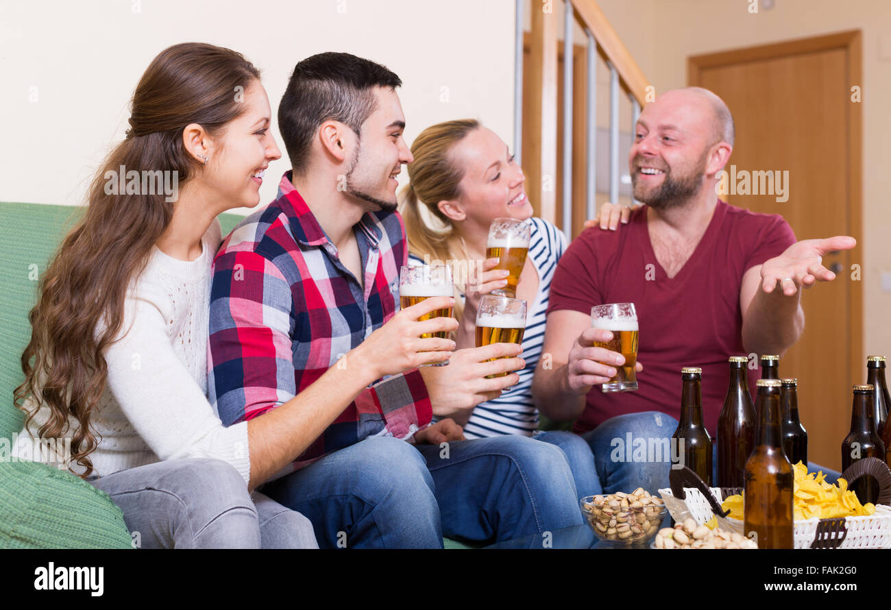 Happy people drinking beer and laughing Stock Photo - Alamy