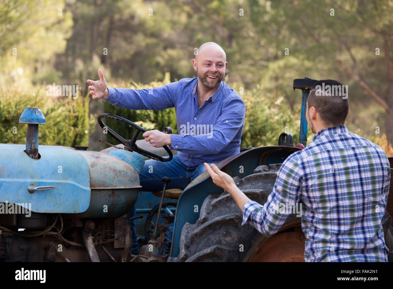 Two happy russian mechanics reparing old agrimotors at farm Stock Photo ...