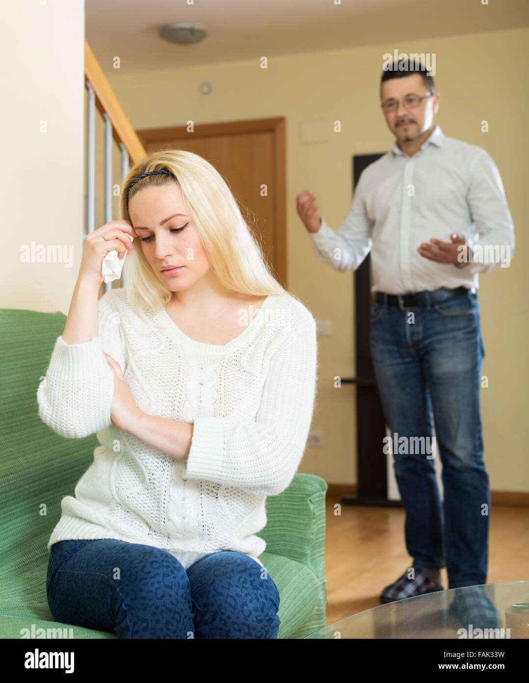Sad married couple after quarrel in living room at home Stock Photo - Alamy