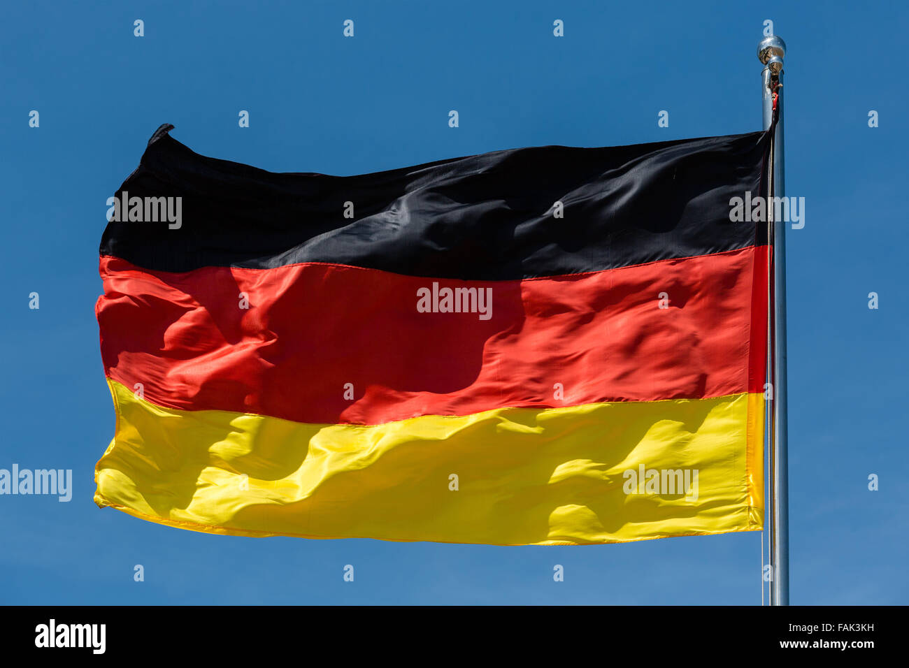 German Flag waving in the wind, blue sky Stock Photo - Alamy