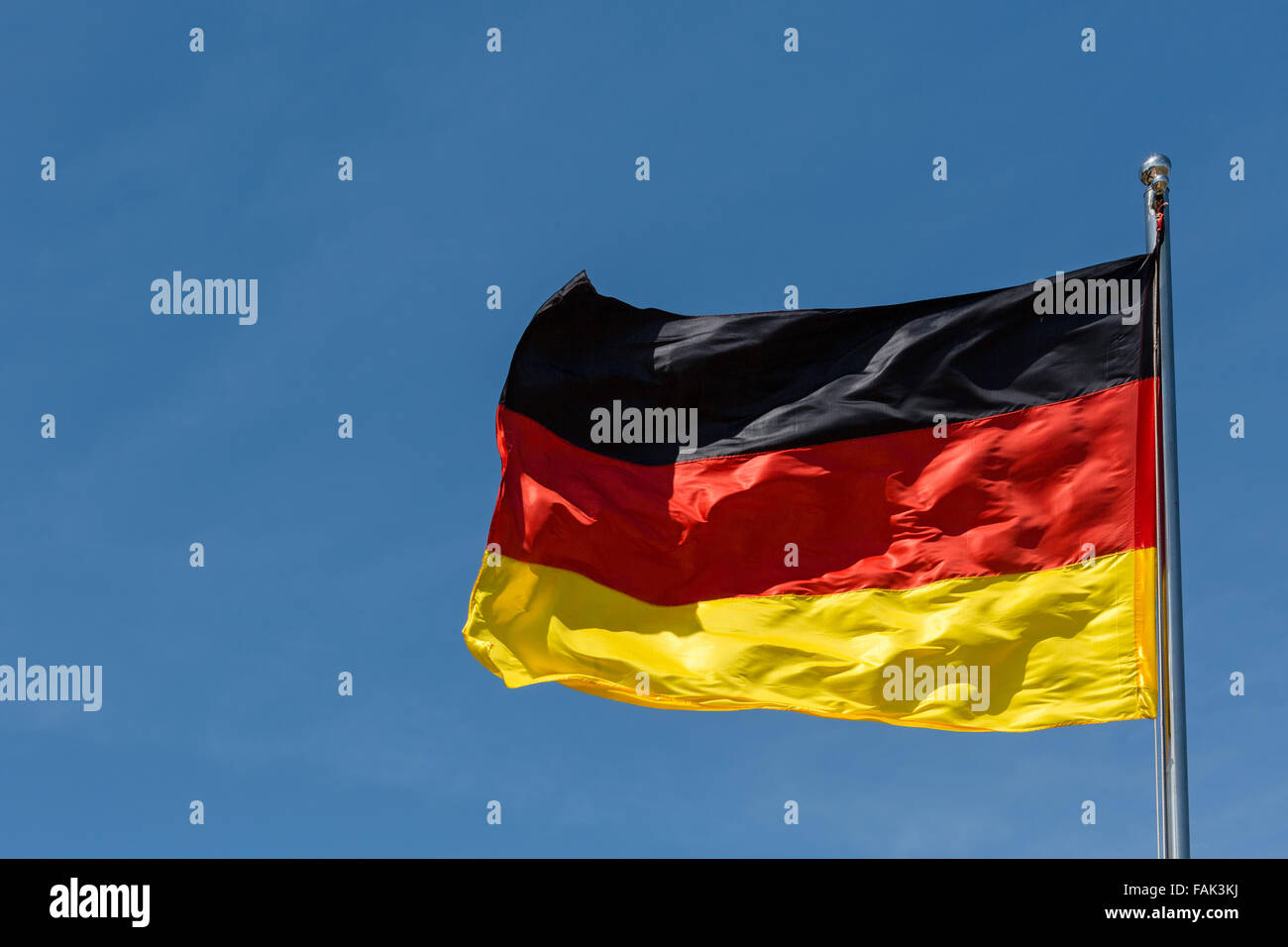 German Flag waving in the wind, blue sky Stock Photo - Alamy