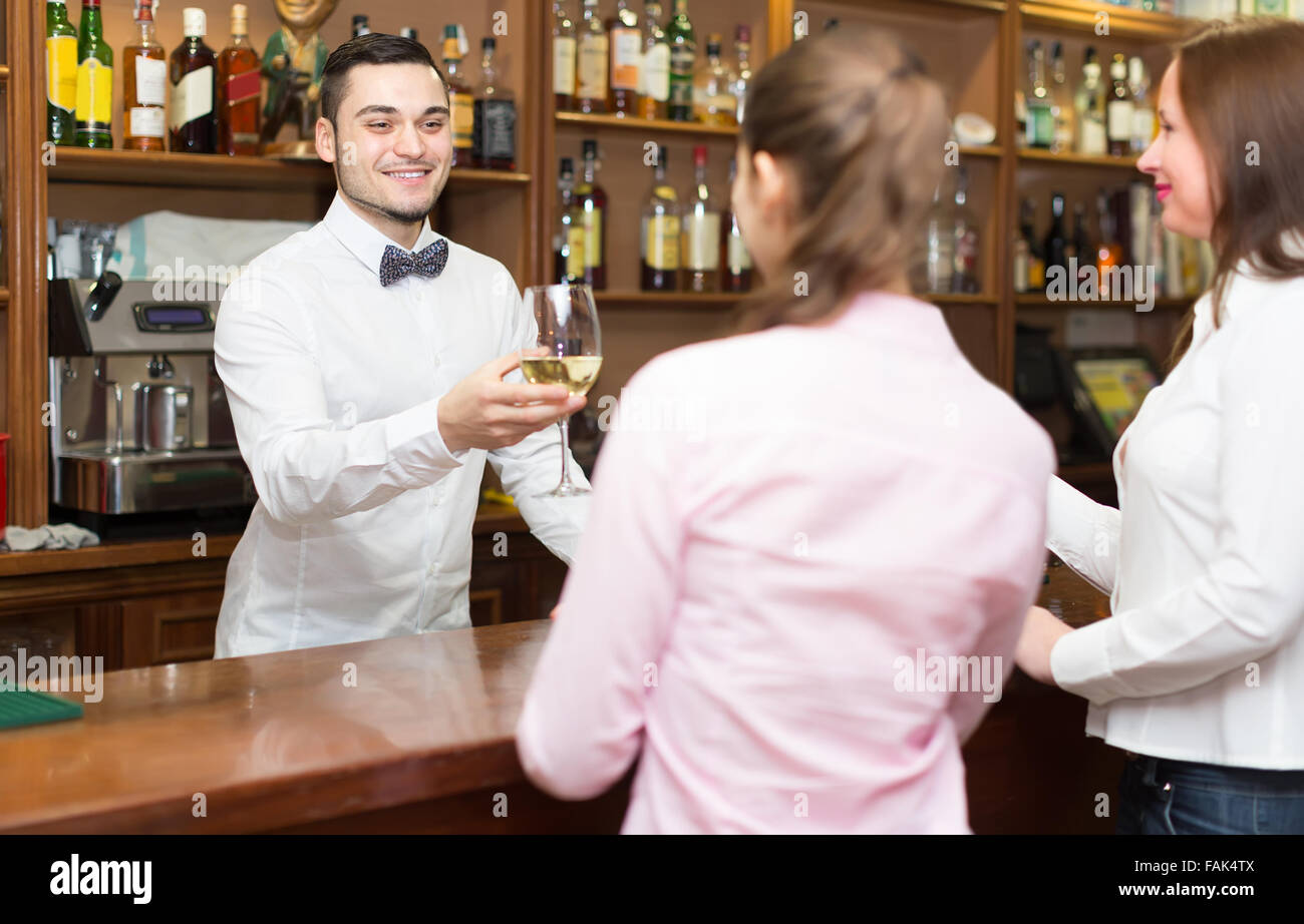 female friends chatting and drinking wine in bar Stock Photo - Alamy